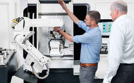 Man and robot hand in hand - DMG MORI India